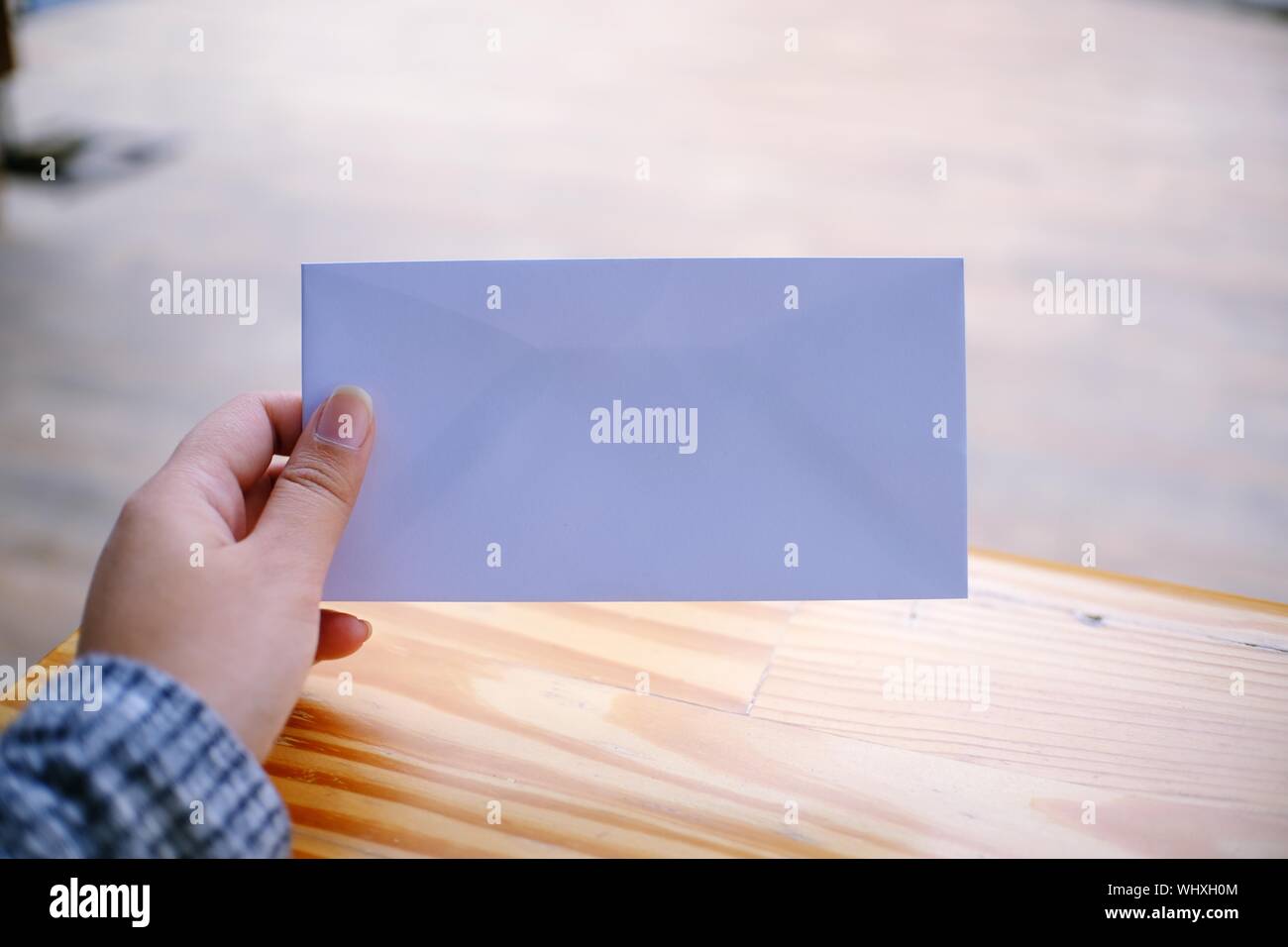 Holding up envelope hi-res stock photography and images - Alamy