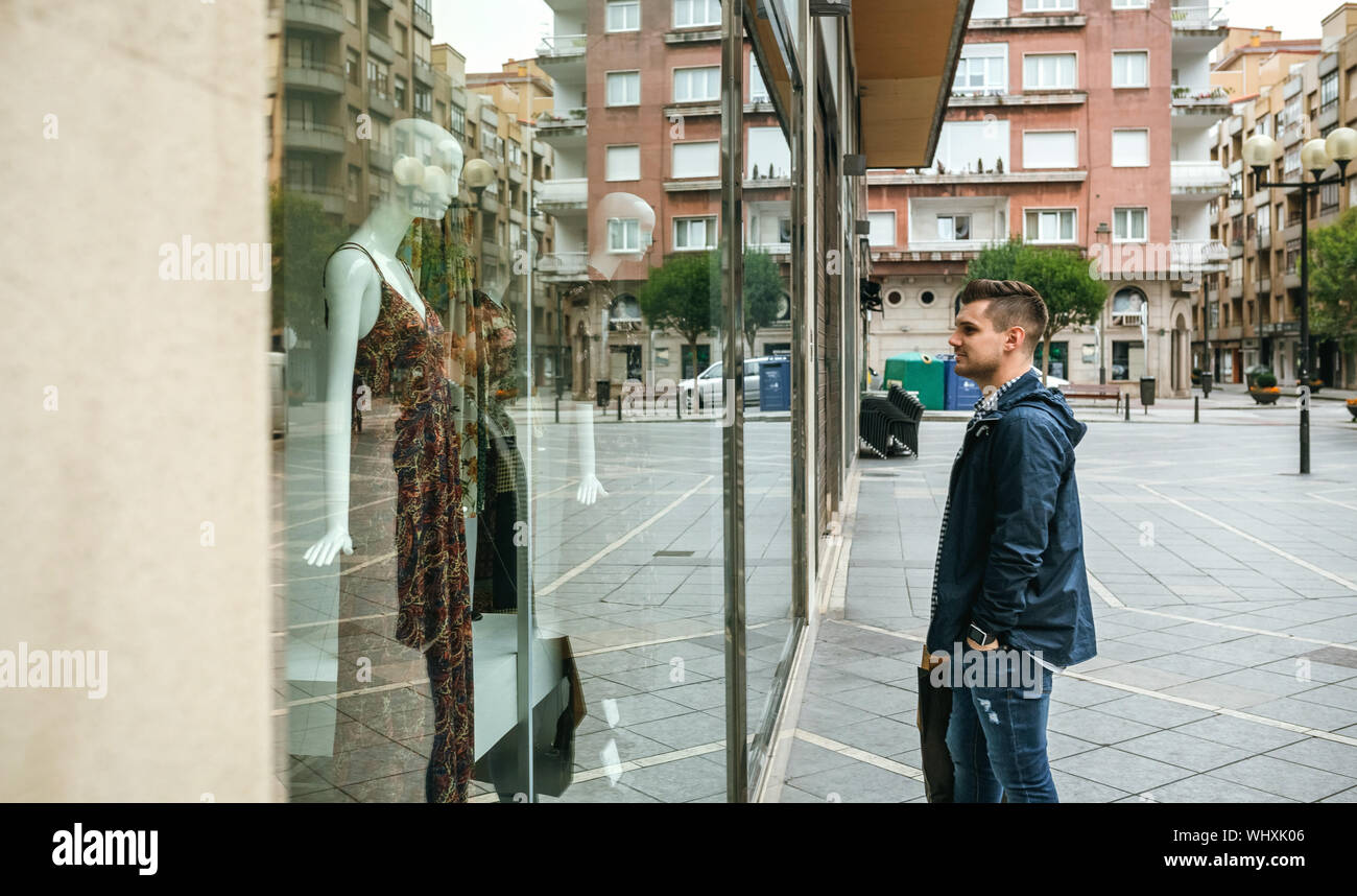 Man looking shop window to buy a gift Stock Photo - Alamy