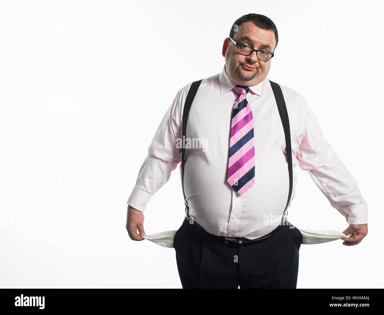 Portrait of an overweight businessman pulling out empty pockets against ...