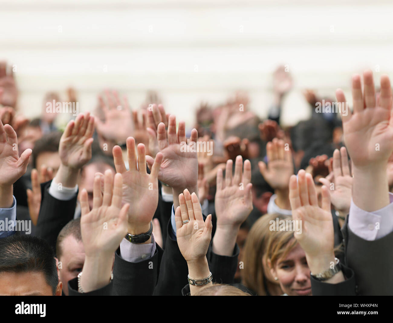Closeup of business crowd raising hands Stock Photo - Alamy