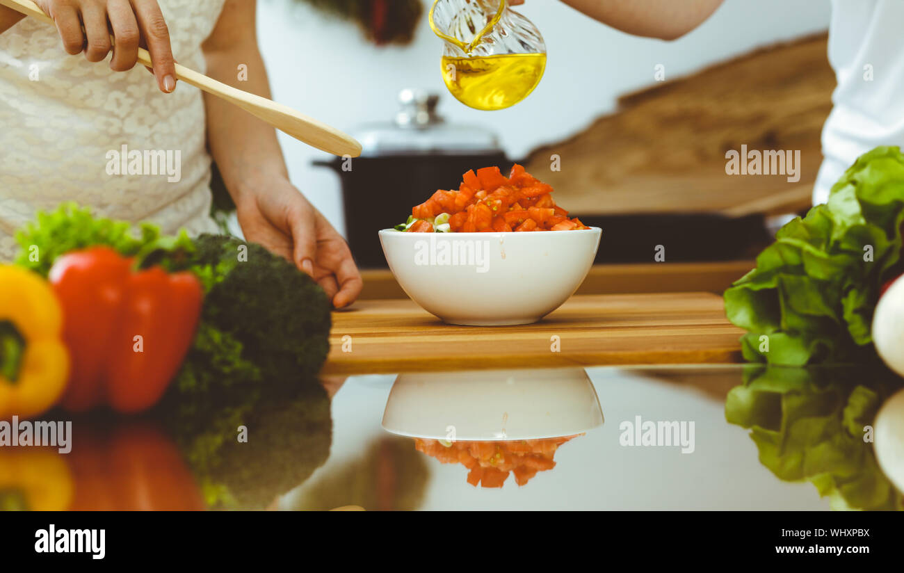 Closeup of human hands cooking in kitchen. Mother and daughter or two ...