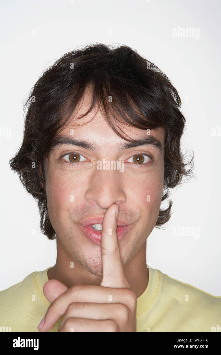 Man with Finger on Lips Stock Photo - Alamy