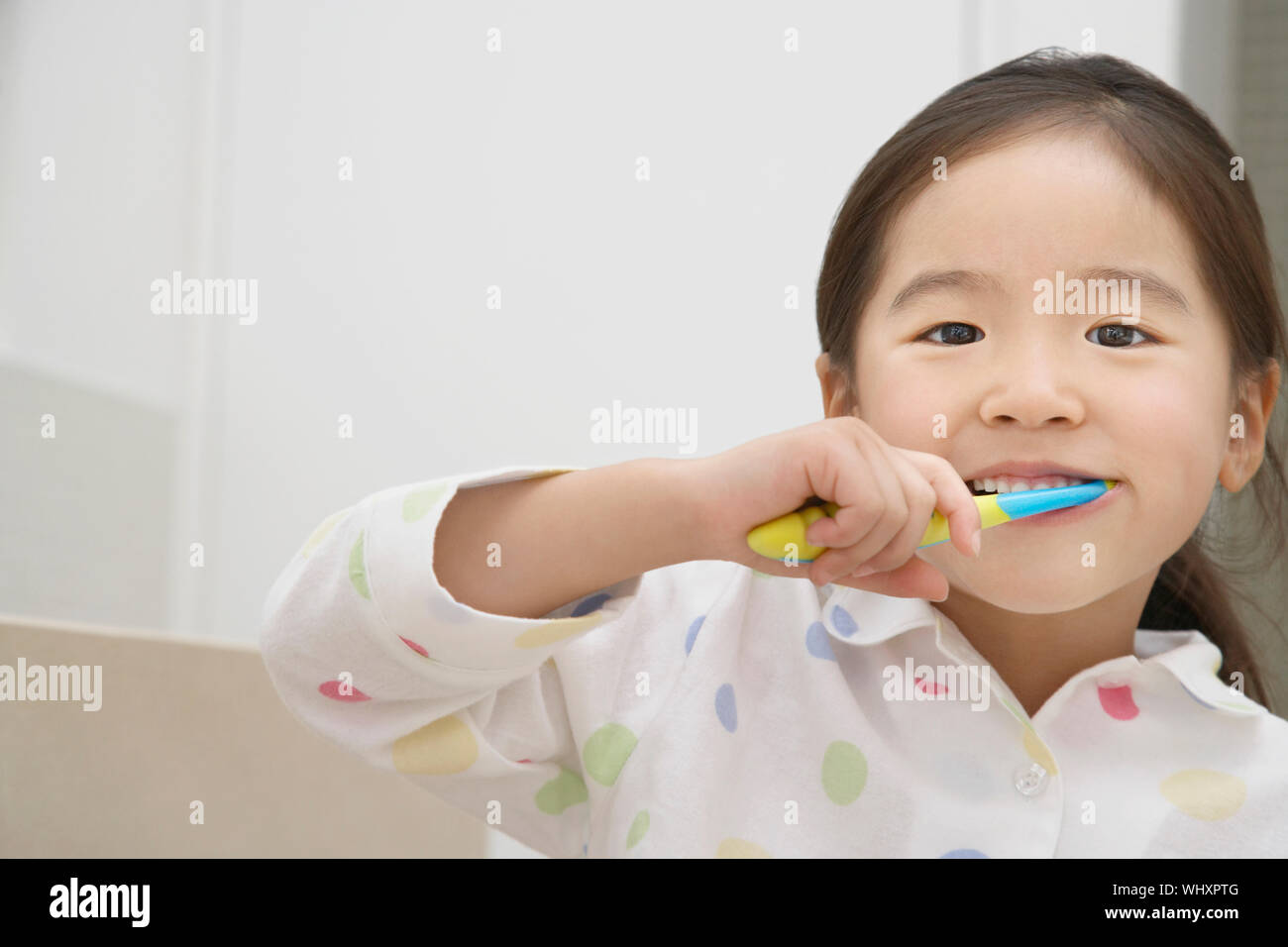 Closeup portrait of a young girl brushing her teeth Stock Photo - Alamy