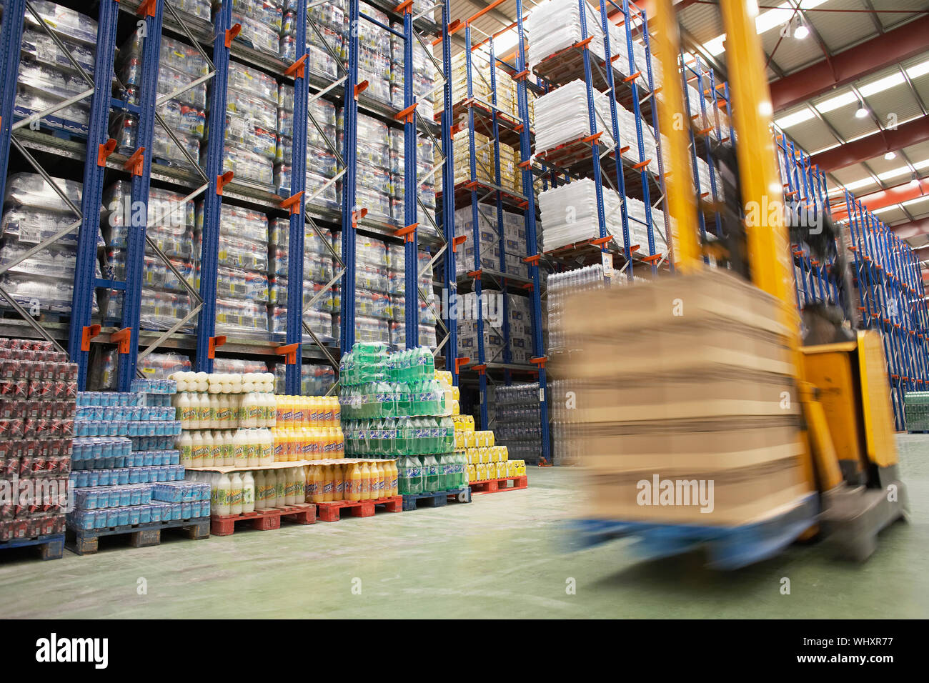View of speeding forklift in warehouse Stock Photo - Alamy