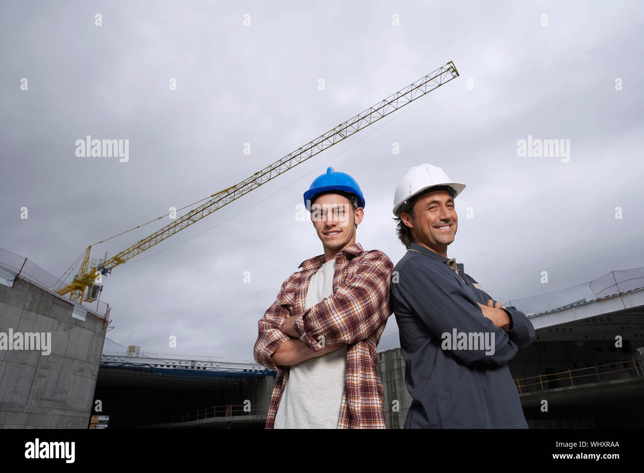 Portrait of two happy construction workers at building site Stock Photo ...
