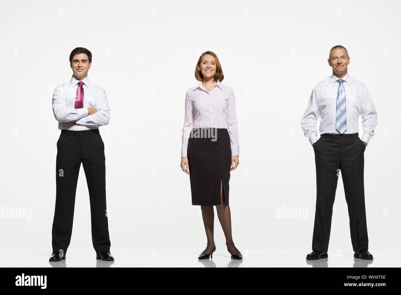 Full length portrait of businesspeople standing side by side against ...