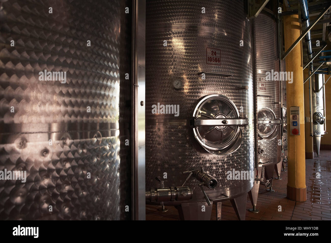 Stainless steel wine vats in a row inside the winery Stock Photo - Alamy