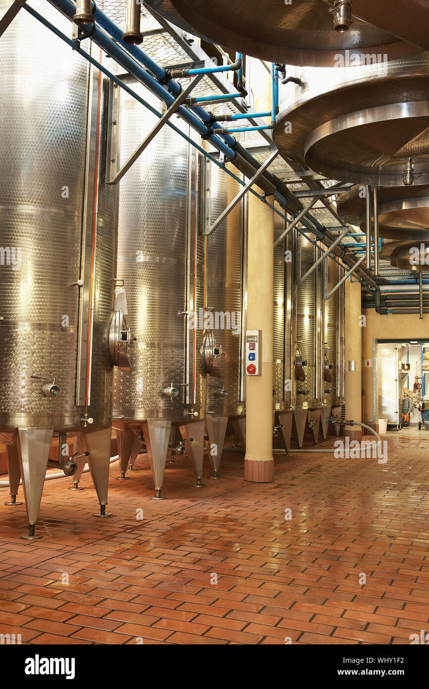 Stainless steel wine vats in a row inside the winery Stock Photo - Alamy