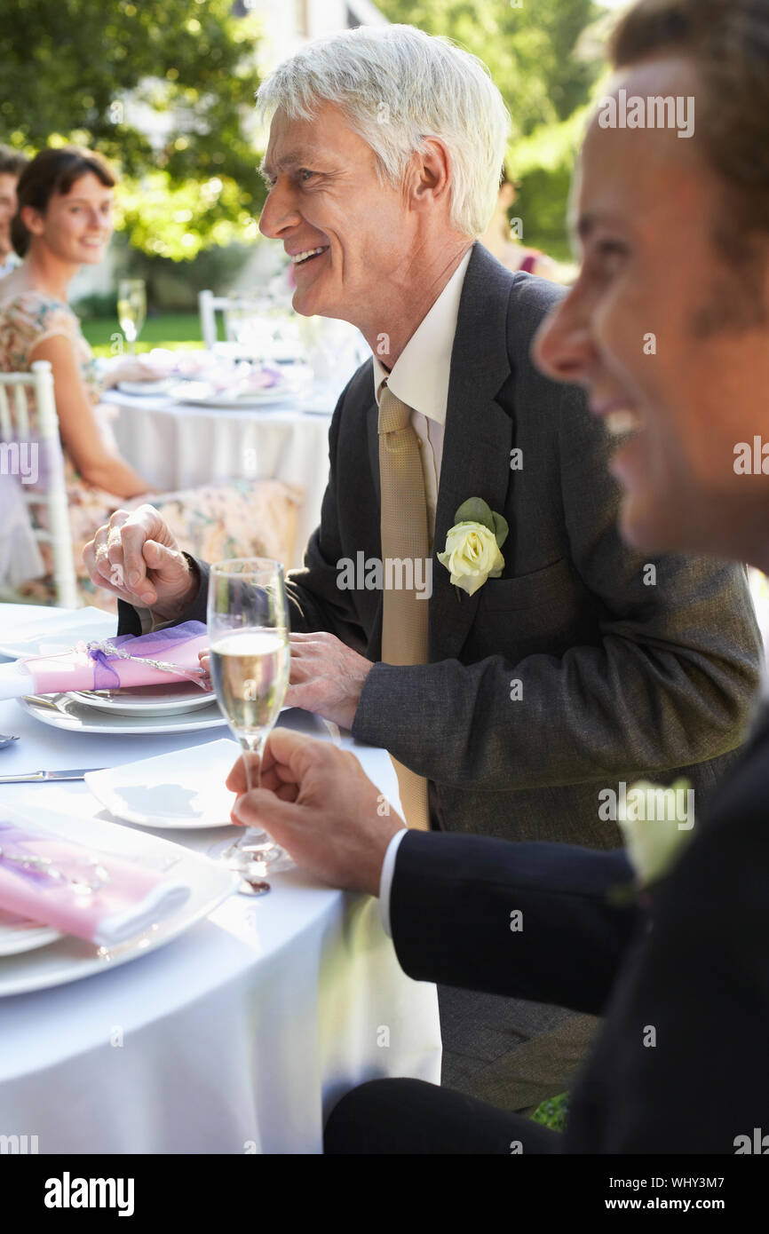 Happy middle aged man with guests in wedding reception Stock Photo - Alamy