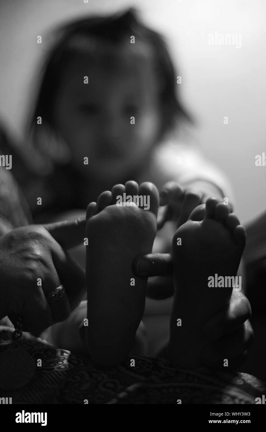 Baby touching feet hi-res stock photography and images - Alamy