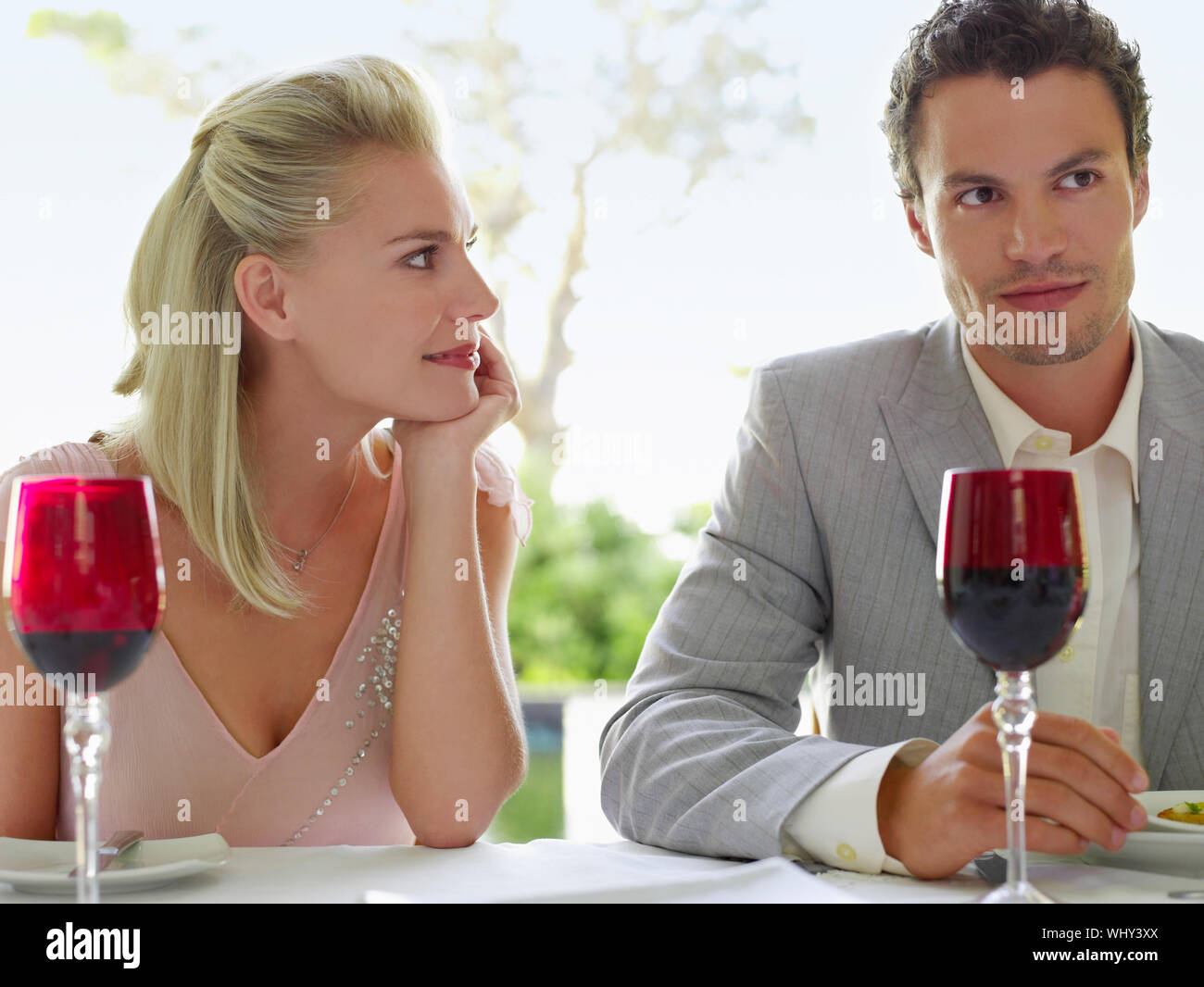 Beautiful young woman admiring man at dinner table Stock Photo - Alamy