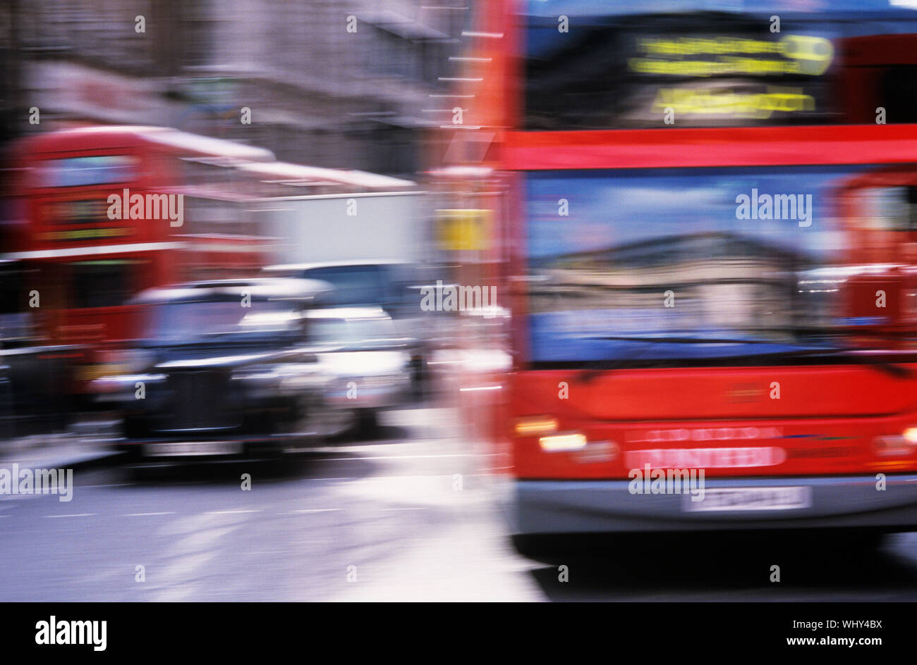 Red buses and black cabs on road in London motion blur Stock Photo - Alamy