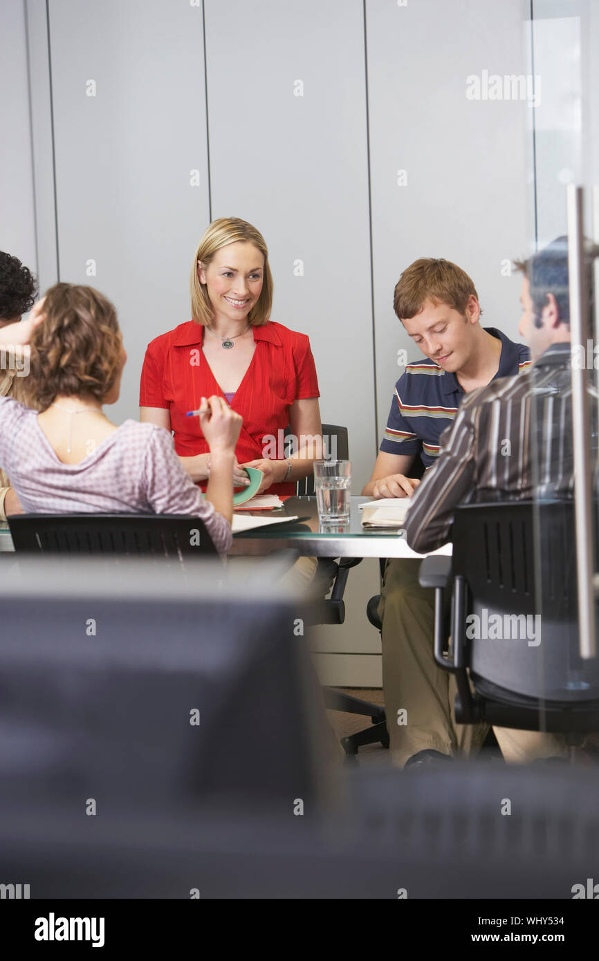 Multiethnic business executives sitting around conference table Stock ...