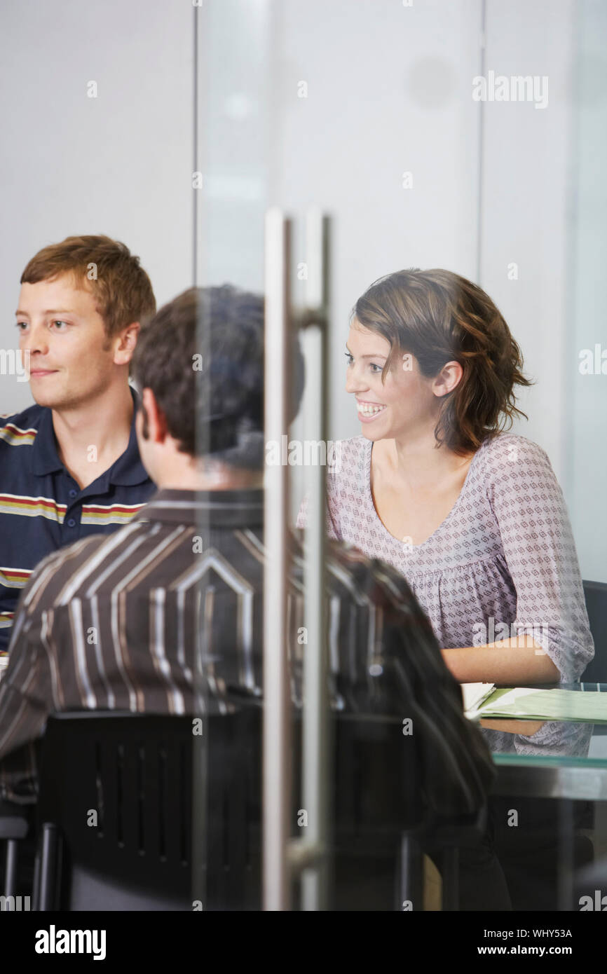 Business executives sitting around conference table Stock Photo - Alamy