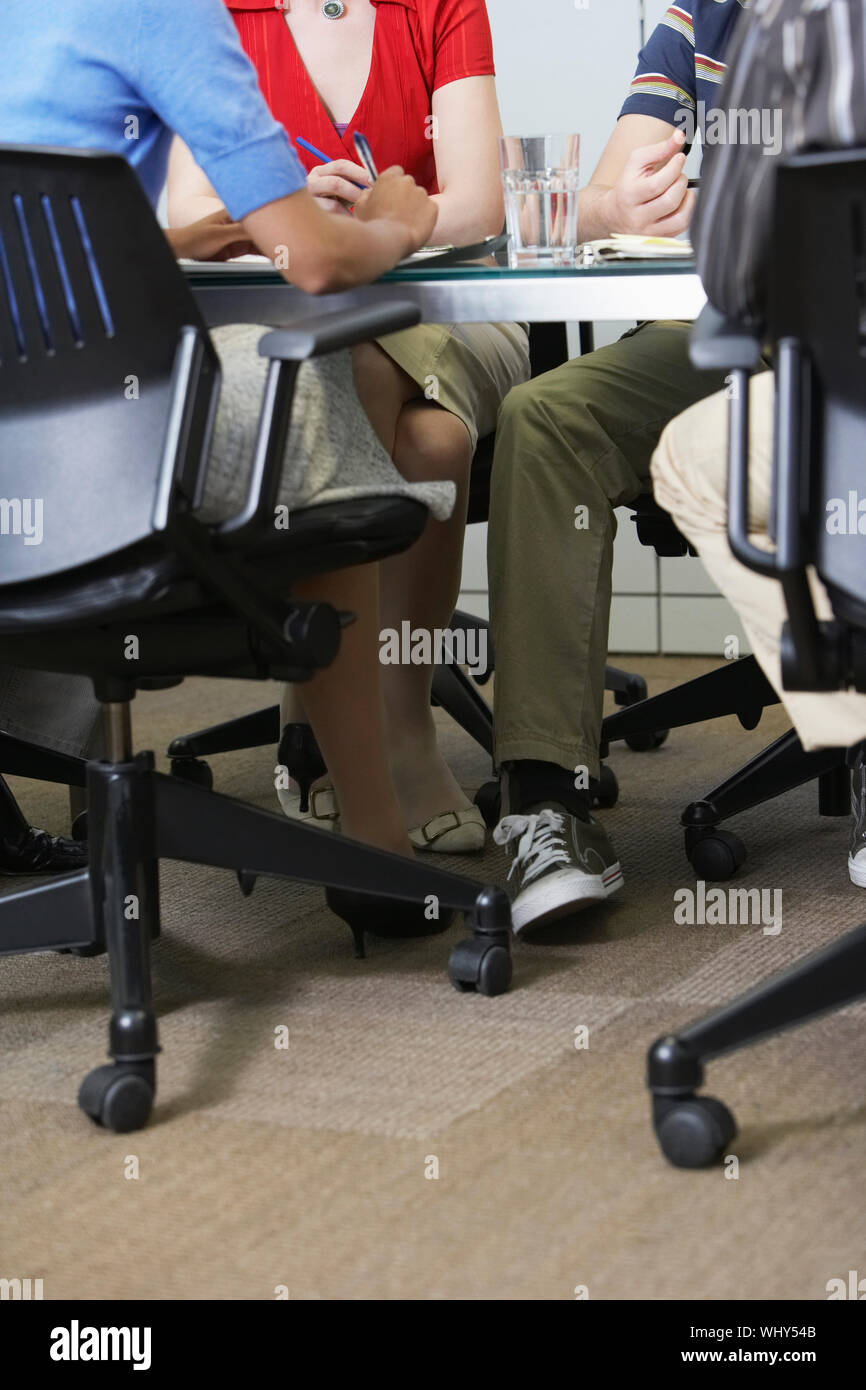 Lowsection of business executives sitting around conference table Stock ...