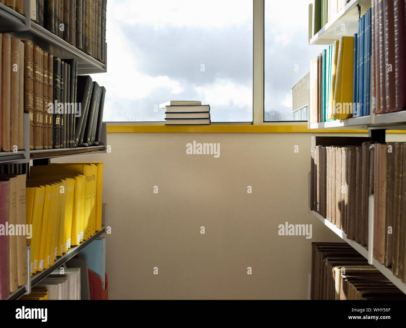 Interior view of a library with pile of books on windowsill Stock Photo ...