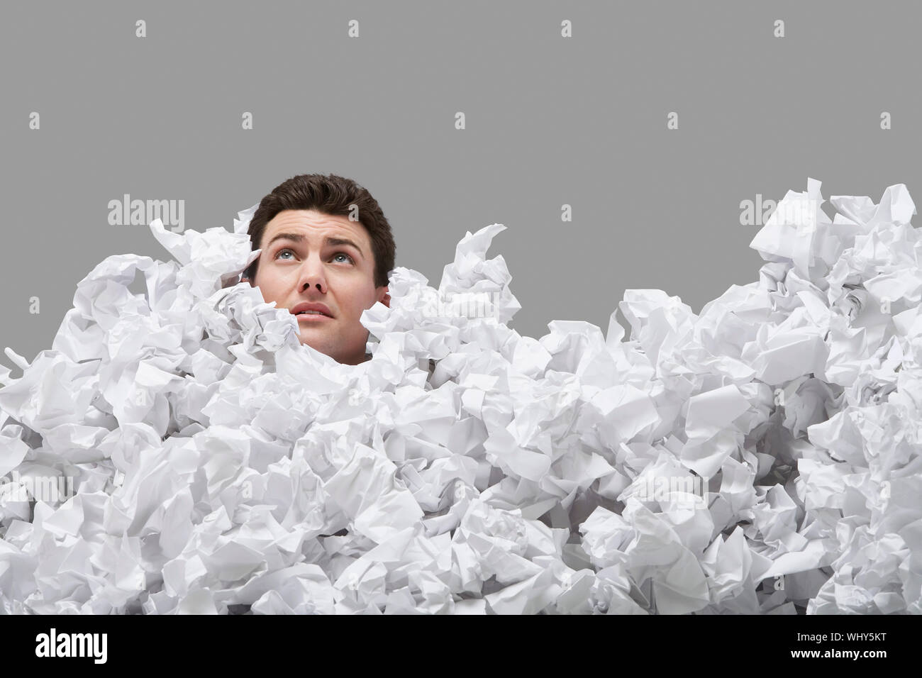 Overworked man pile of papers hi-res stock photography and images - Alamy