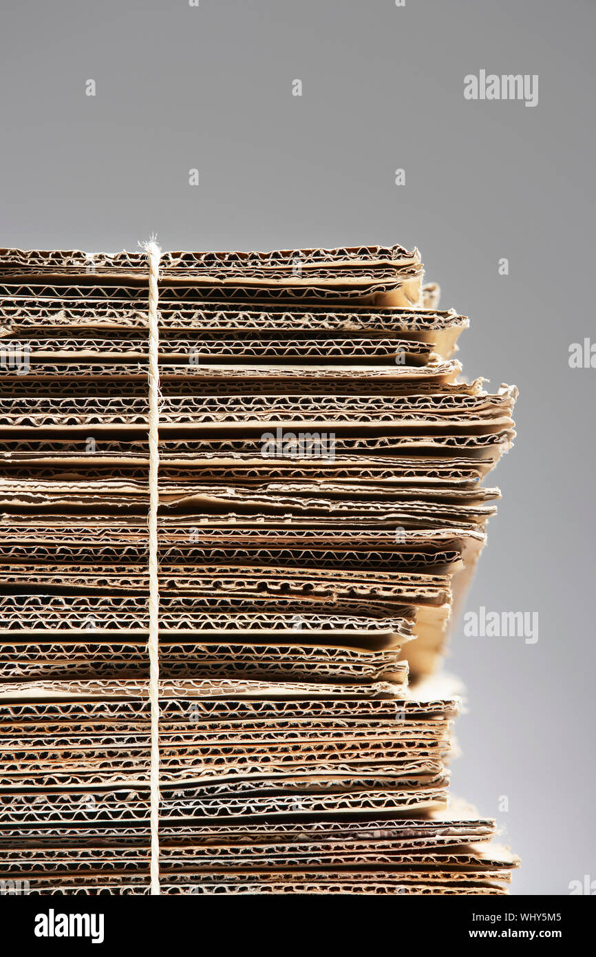 Bundle of waste cardboard tied with string close-up Stock Photo - Alamy