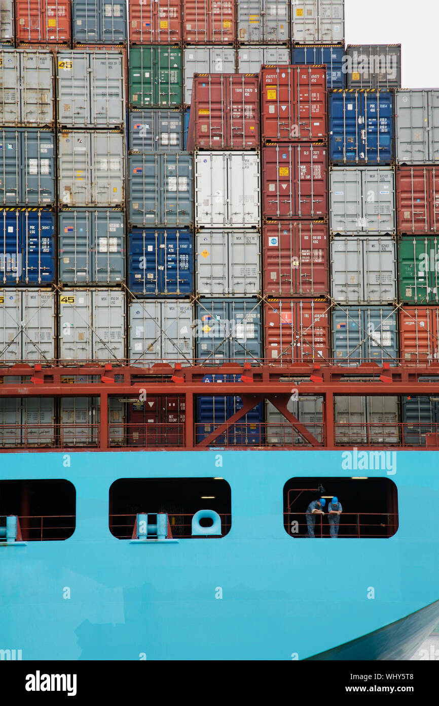 Two men on container ship Stock Photo - Alamy