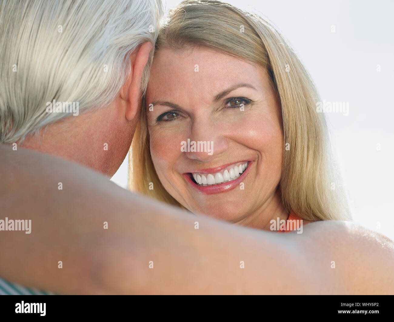 Closeup portrait of a happy middle aged woman embracing man outdoors ...
