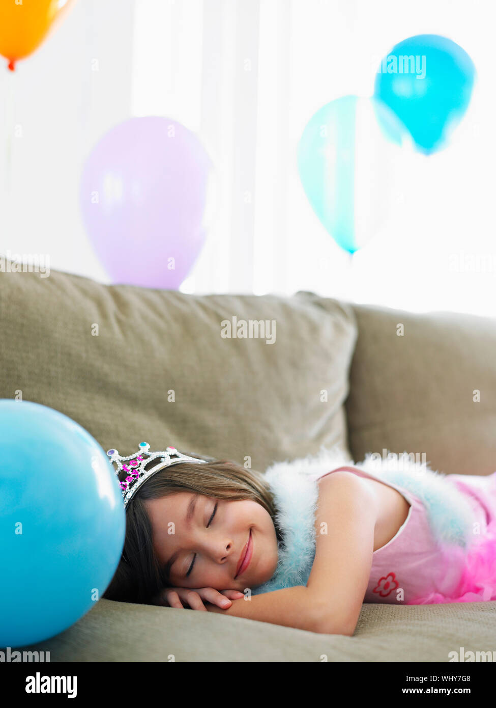 Young smiling girl sleeping on sofa with balloons Stock Photo - Alamy