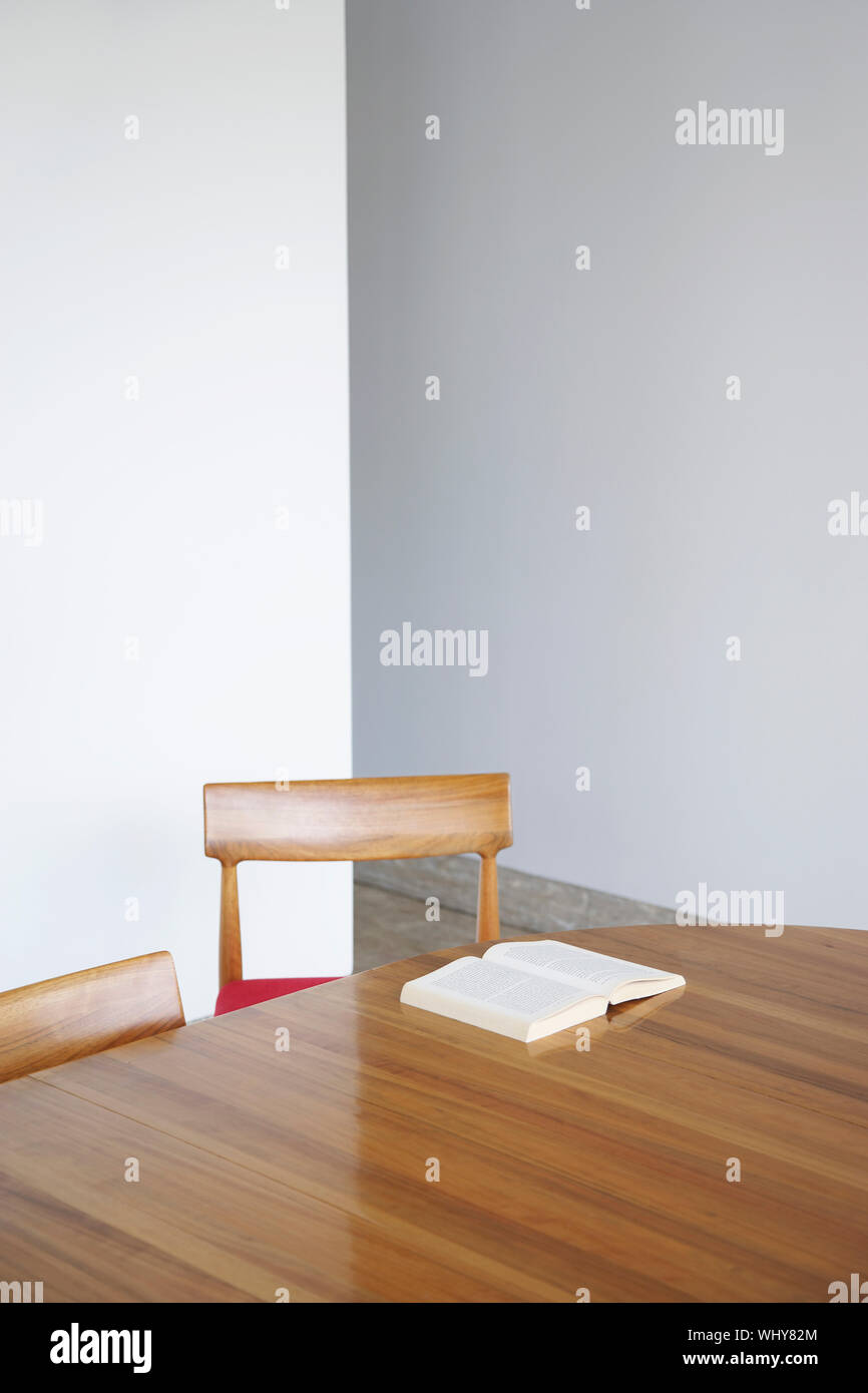 Open book on wooden dining table at home Stock Photo - Alamy