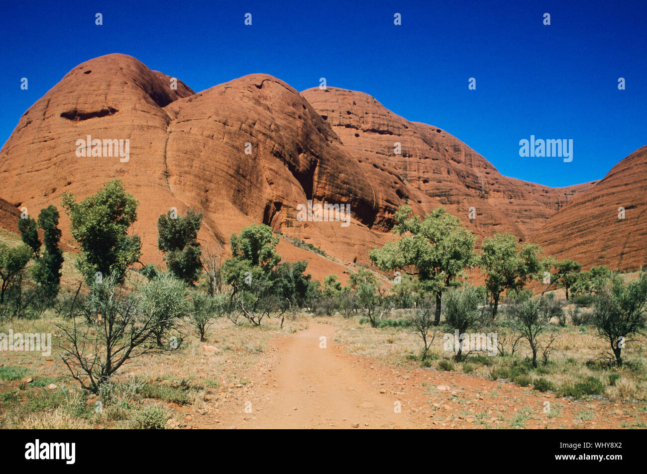 Dirt track leading towards rock formation Stock Photo - Alamy