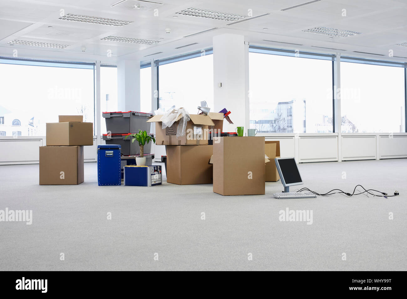 Cartons and equipment on floor of empty office space Stock Photo - Alamy