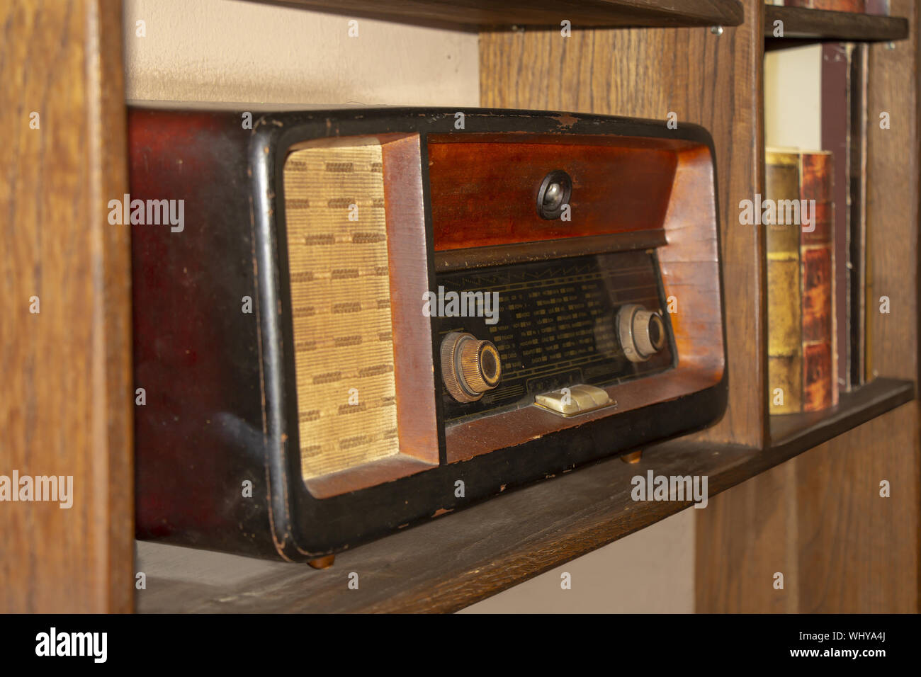 Old vintage radio on the wooden shelf with books Stock Photo - Alamy