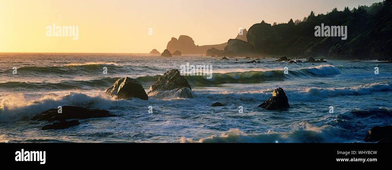 Surf at sunset Stock Photo - Alamy