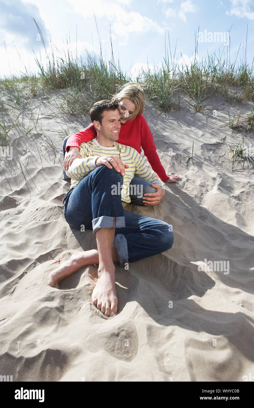 Full length of loving couple spending time together on sandy beach ...