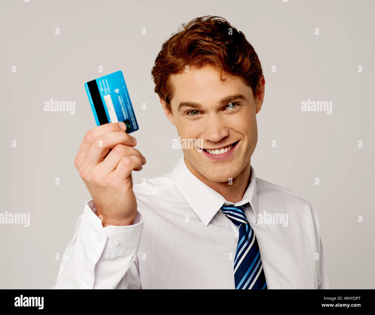 Young corporate guy showing his debit card Stock Photo - Alamy