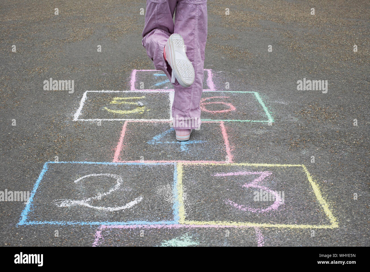 Low section of girl playing hop-scotch in playground Stock Photo - Alamy