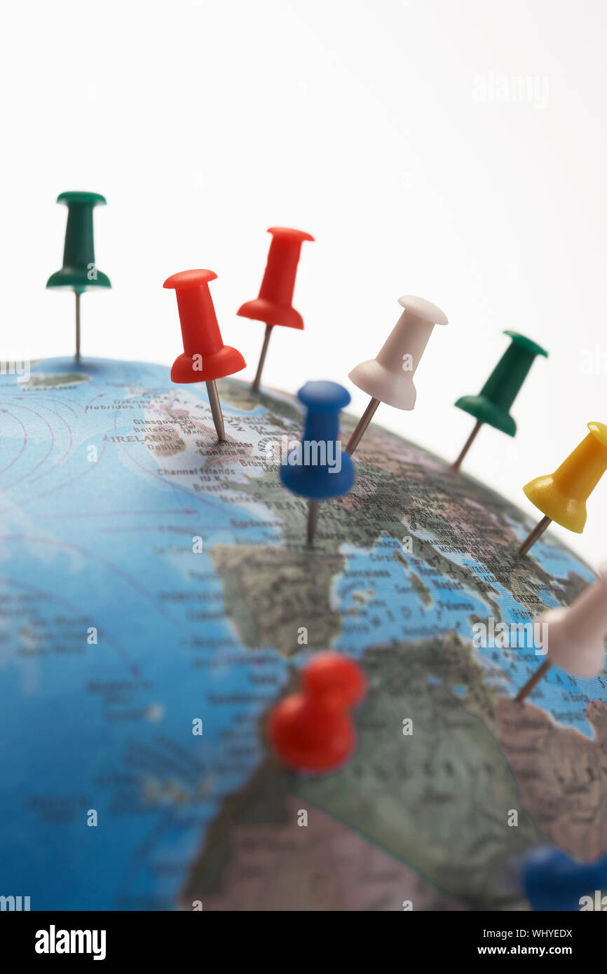 Push pins in various parts of globe studio shot close up Stock Photo ...
