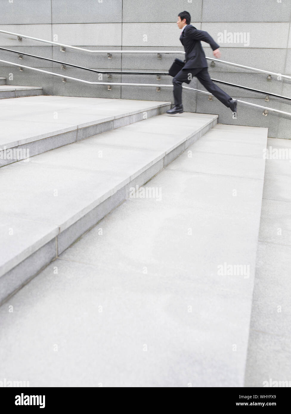 Man running up steps briefcase hi-res stock photography and images - Alamy