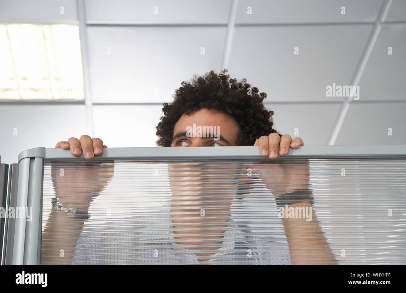 Man peeking over cubicle wall hi-res stock photography and images - Alamy