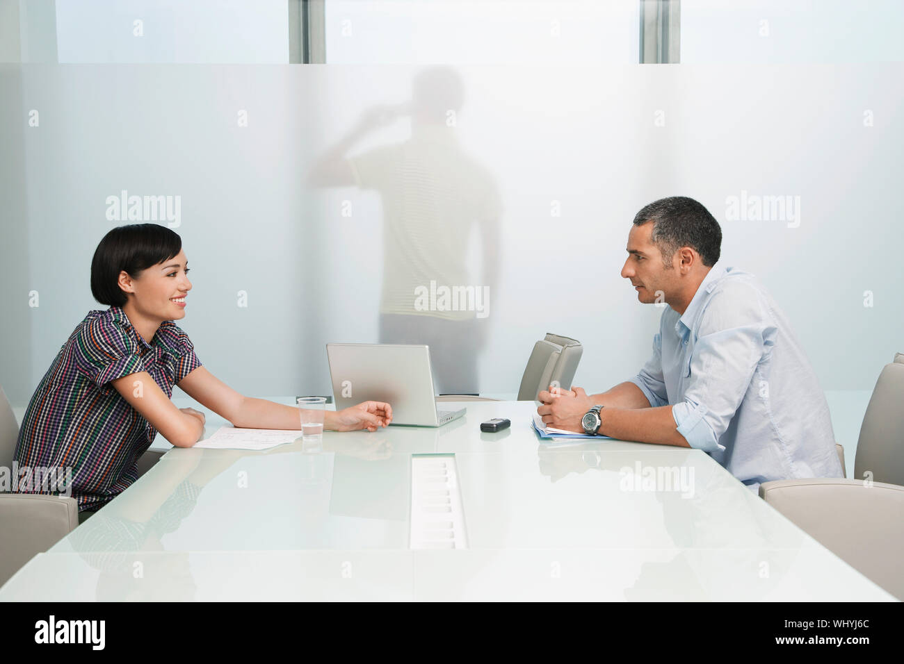 Man woman sitting across desk interview hi-res stock photography and ...