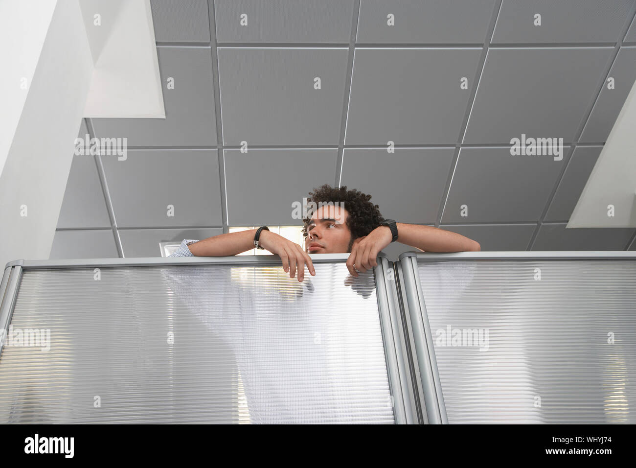 Man peeking over cubicle wall hi-res stock photography and images - Alamy