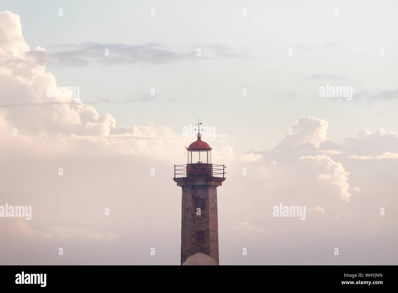 Beautiful shot of a tall lighthouse tower beacon at the shore of the ...