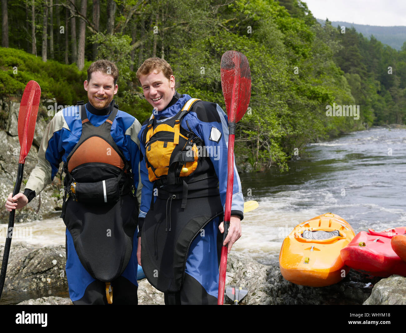 Portrait of two young men with kayaks by the river Stock Photo - Alamy