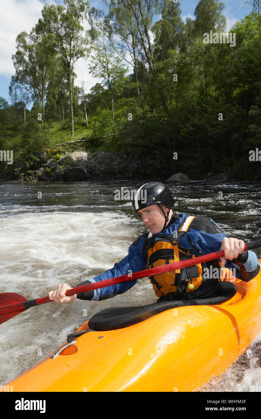 View of a young man kayaking in river Stock Photo - Alamy