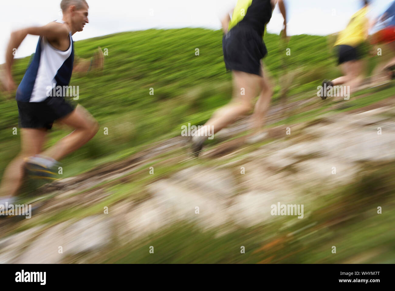 Side view of blurred group of people running on track Stock Photo - Alamy