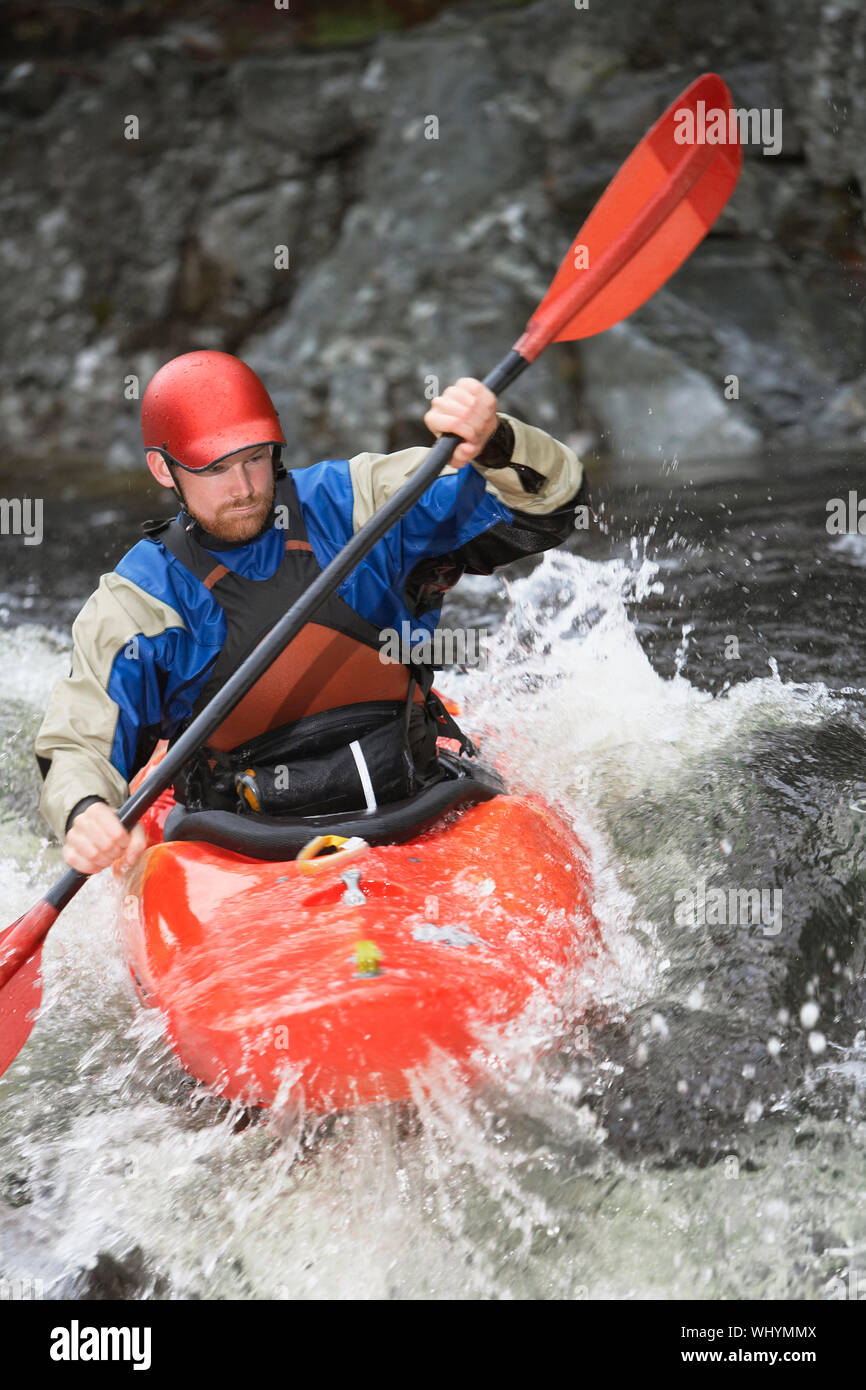 View of a young man kayaking in rough river Stock Photo - Alamy