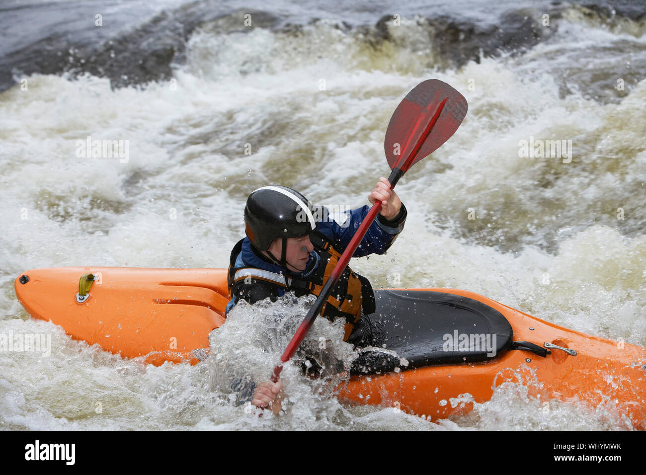 Side view of a man kayaking in rough river Stock Photo - Alamy