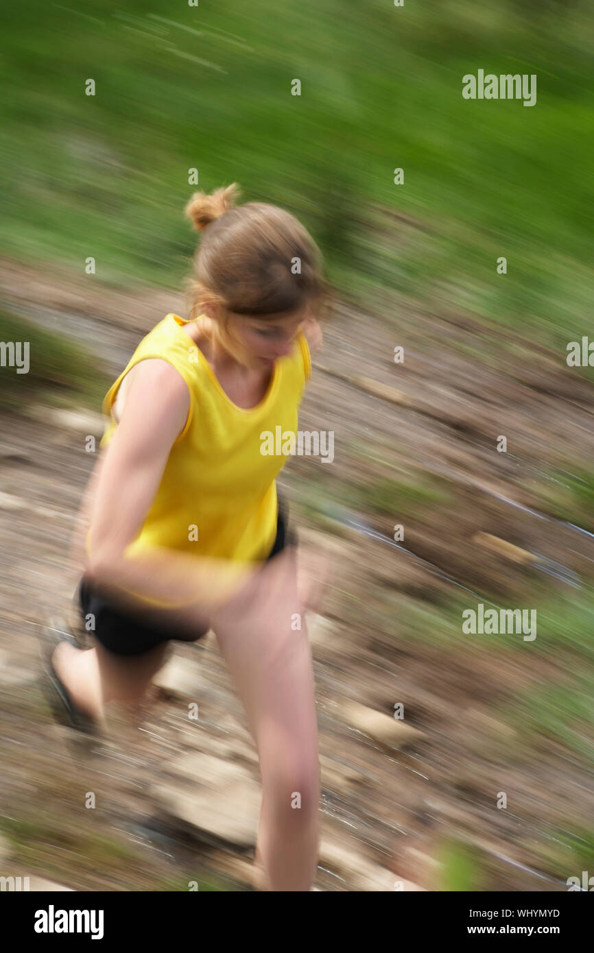 Elevated view of a woman running on track Stock Photo - Alamy