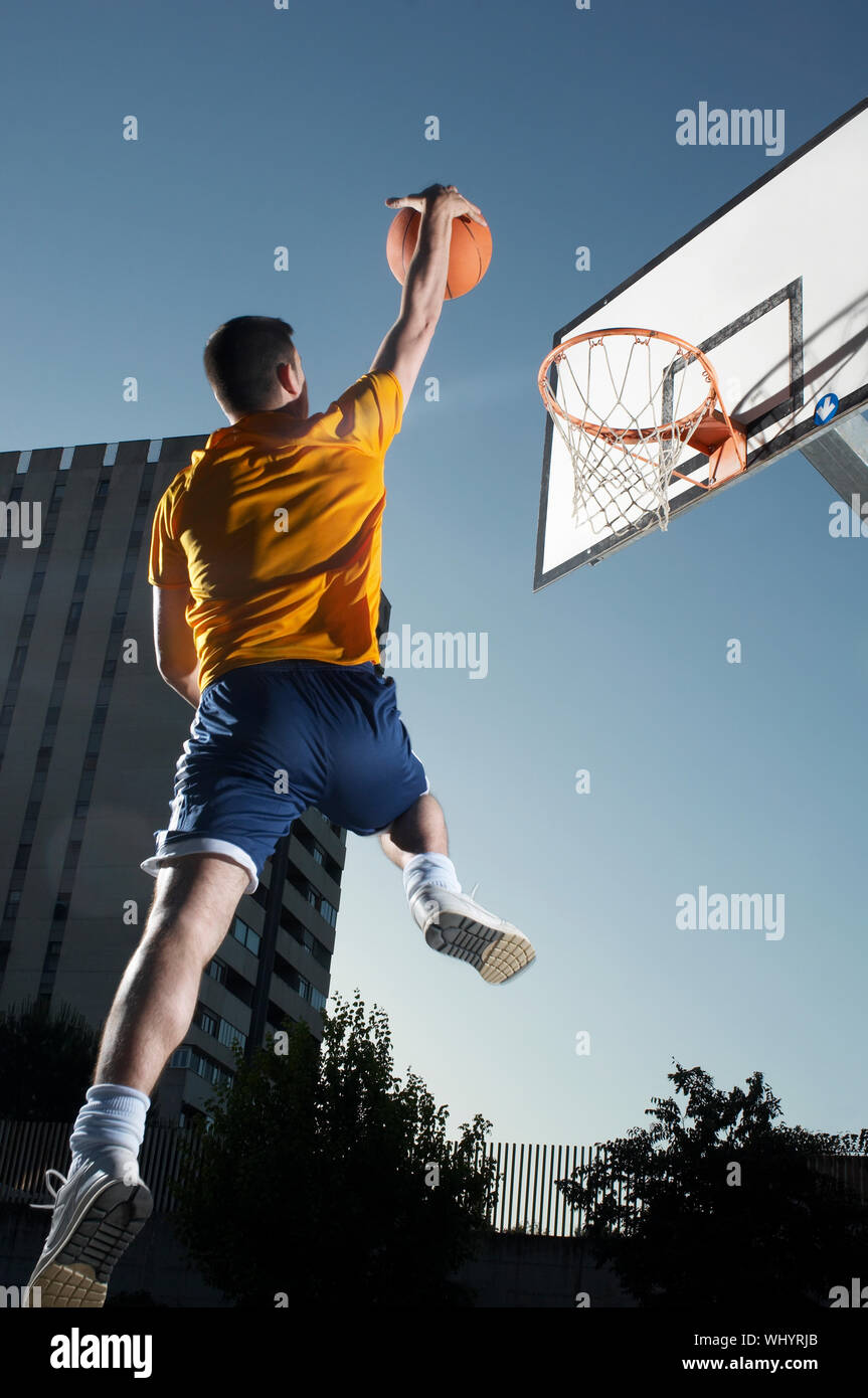 Man dunking basketball low angle hi-res stock photography and images ...