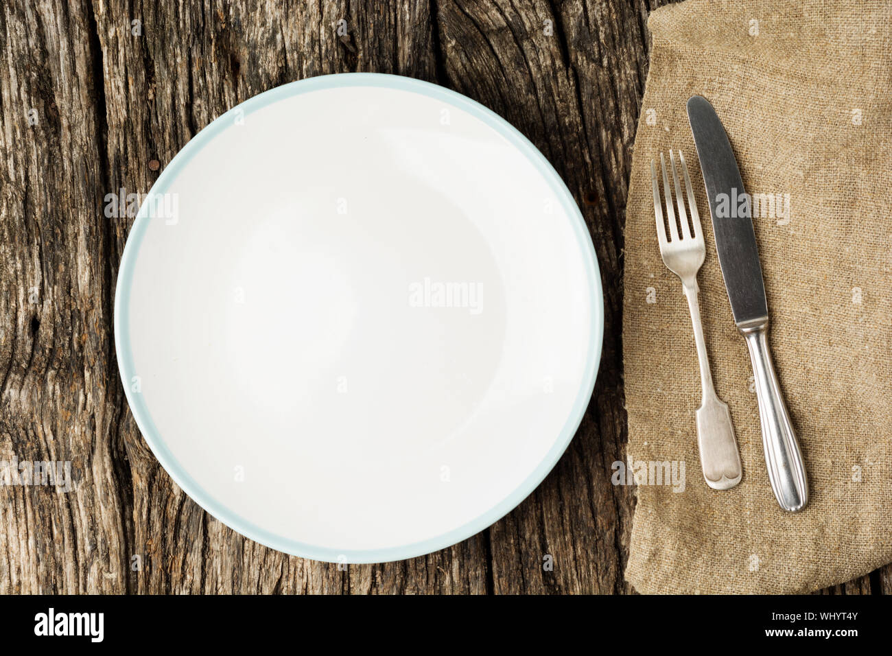Table setting with vintage silverware or cutlery and empty plate on ...