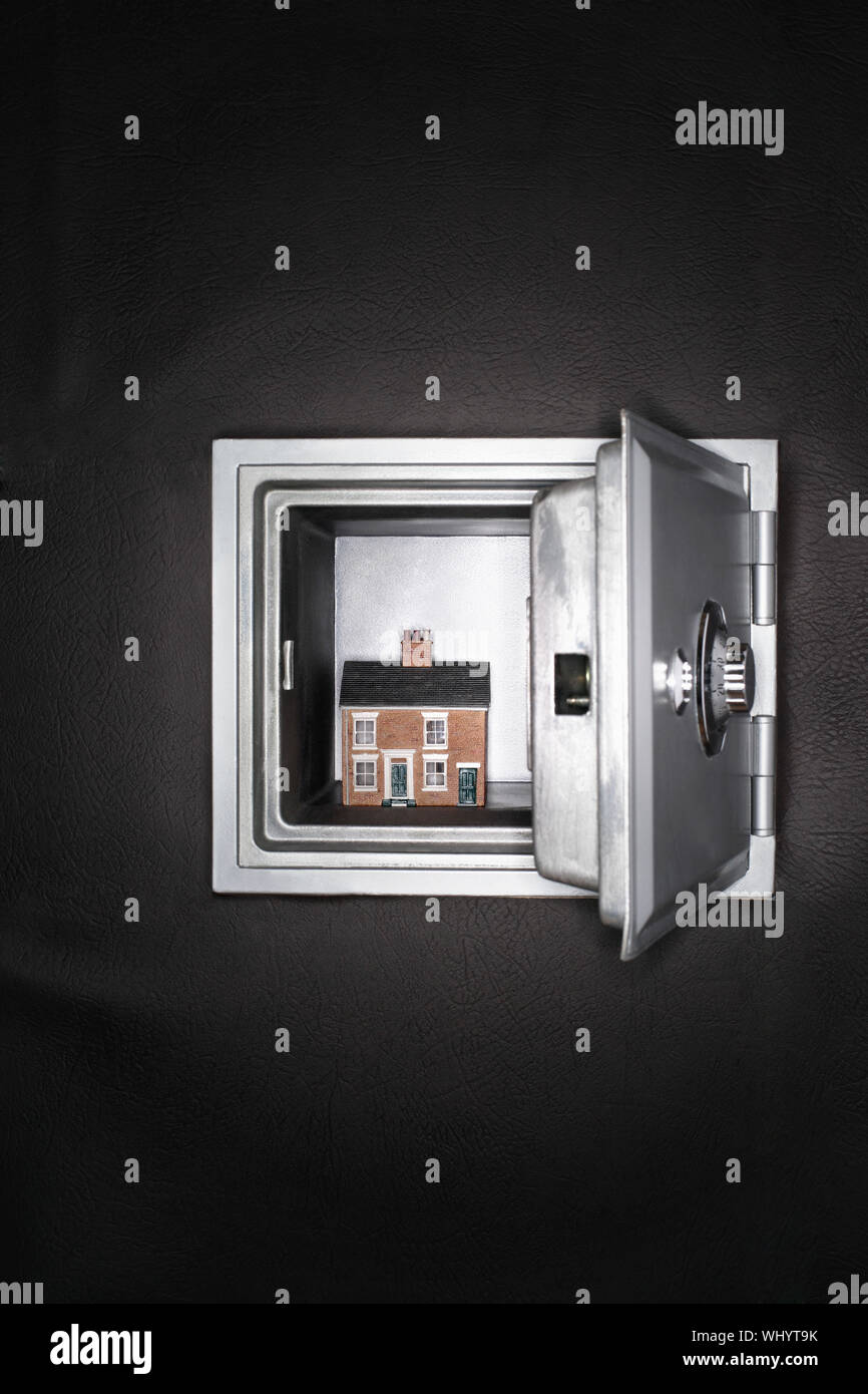 Ceramic house in opened safe Stock Photo - Alamy