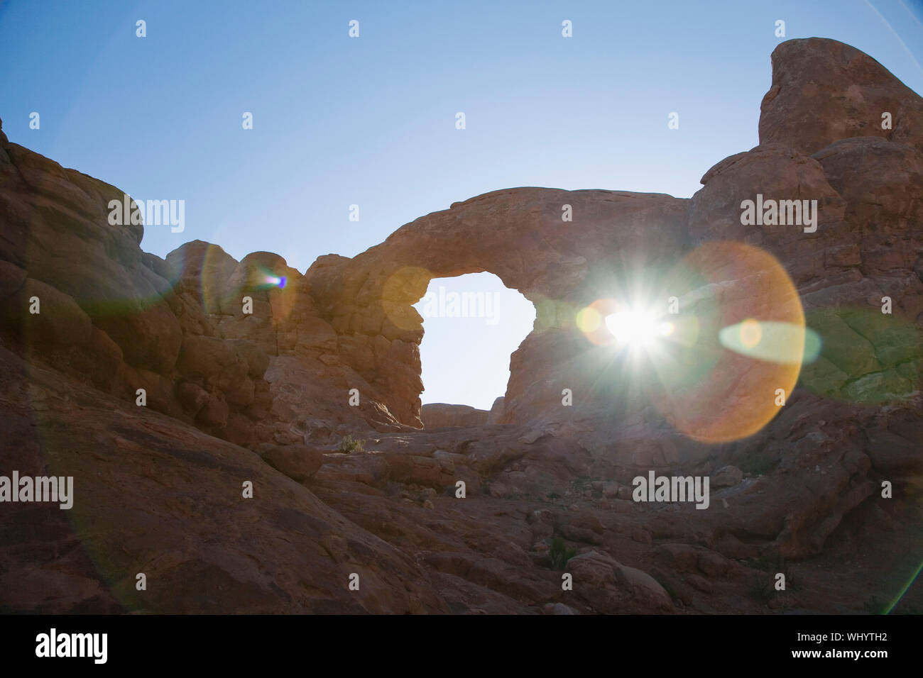 USA, sun shining through rock formation in desert Stock Photo - Alamy