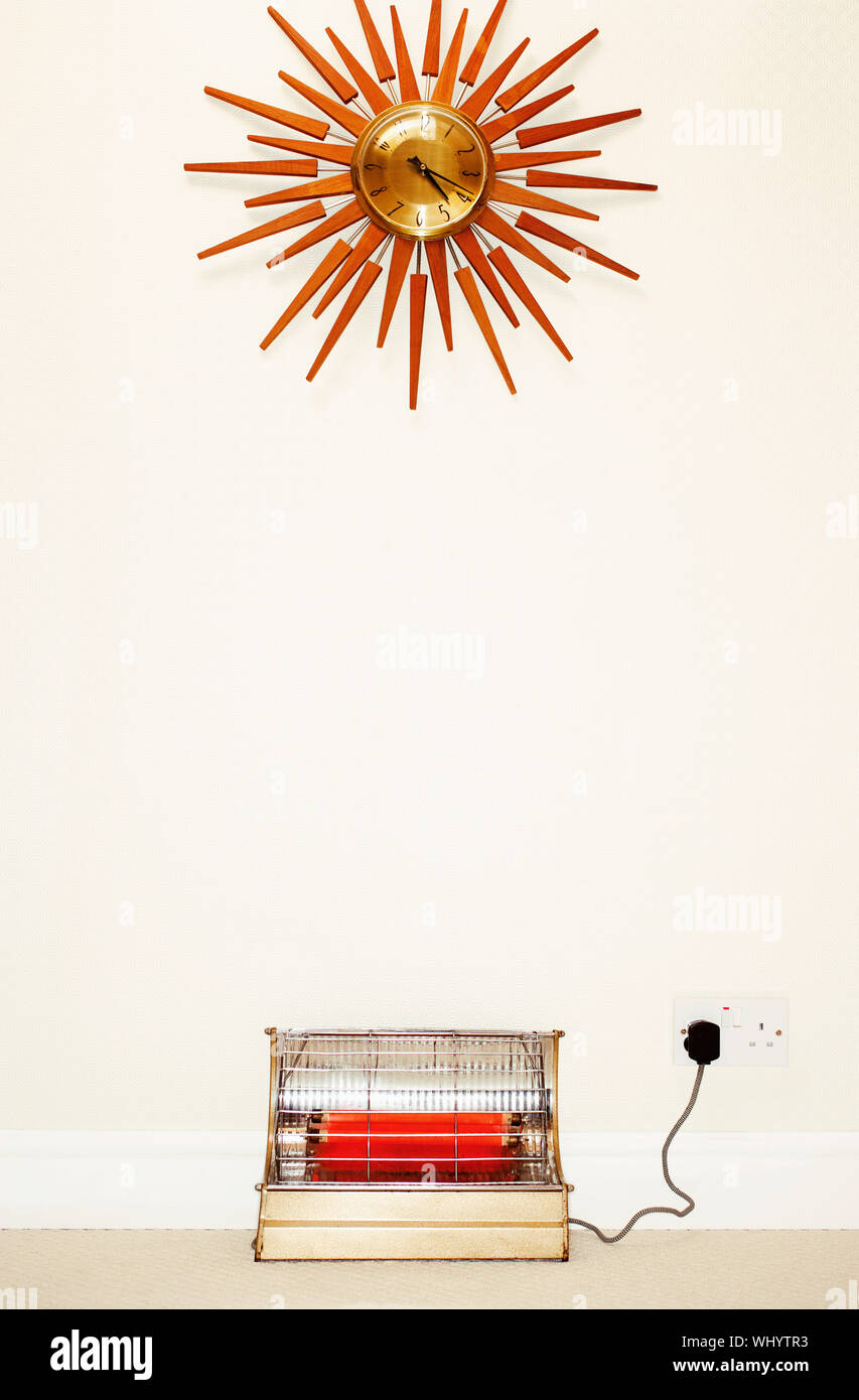 Old fashioned wall clock and heater Stock Photo - Alamy